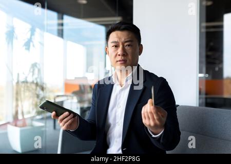 Unhappy Confused, angry asian man shopping online. customer cannot pay ...