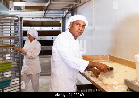 Latino bakery chef preparing dough in bakery Stock Photo - Alamy
