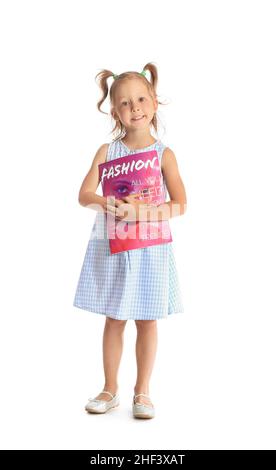 Beautiful little girl reading magazine Stock Photo - Alamy