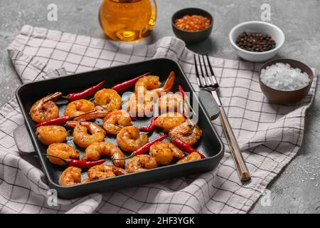 Baking dish of tasty shrimp tails on grey background Stock Photo - Alamy