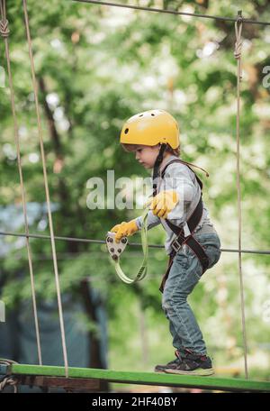 High ropes walk. Balance beam and rope bridges. Happy Little child ...