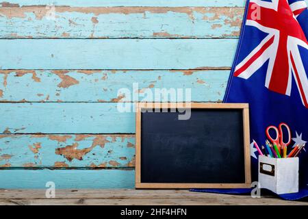 Blank writing slate with copy space by usa flag on blue wooden table ...