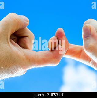 two fingers are connected with blue sky Stock Photo - Alamy