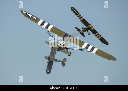Trio of L4 Cub planes flying at an airshow. Piper L-4 Grasshopper ...