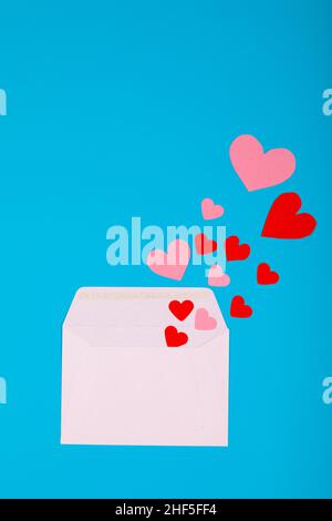 Envelope and red hearts on pink background. Valentine's day, love ...