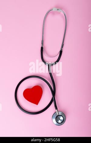 Red heart and stethoscope on a pink background. High quality photo ...