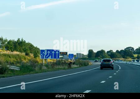 Blue Road Merge Motorway Sign Post, UK Stock Photo - Alamy