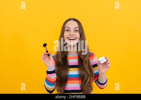 I love changing my makeup. Happy child apply cosmetics. Girl smile ...