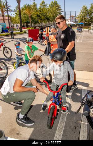 Helmet-wearing children gather in a suburban Southern California park ...