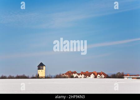 beautiful landscape with water tower and housing area in winter and ...