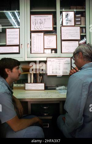 Scientists examine a graph Stock Photo - Alamy