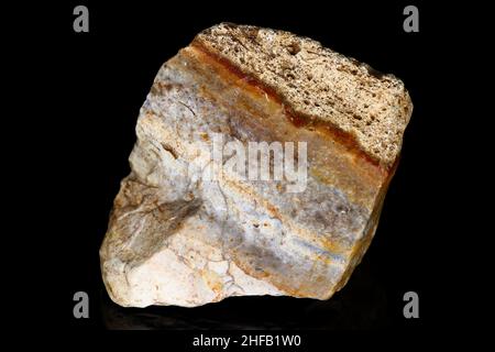 Sample of raw flint with stripes of different shades on a black ...