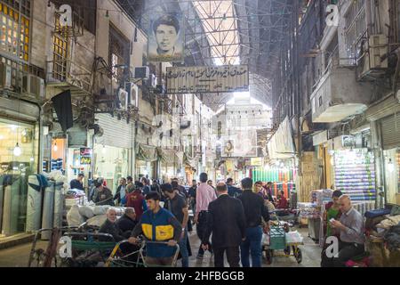 Shoppers and traders walking past market stalls through a busy Grand ...