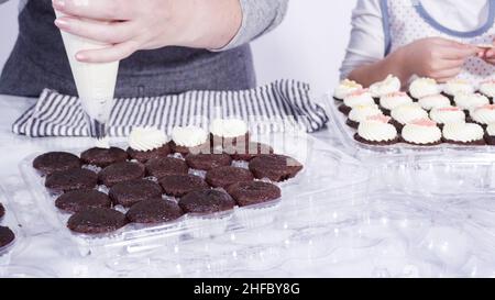 Step by step. Piping Italian buttercream frosting on top of mini ...
