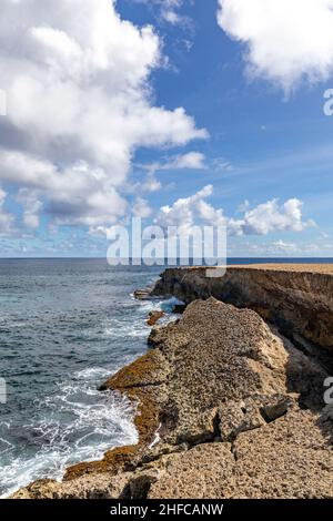 Rocky cliff where people cave dive Aruba Stock Photo - Alamy