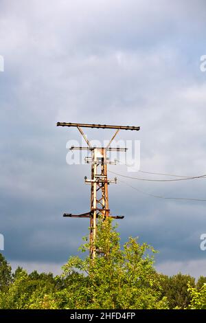 old rusty electrical tower with dark clouds Stock Photo - Alamy