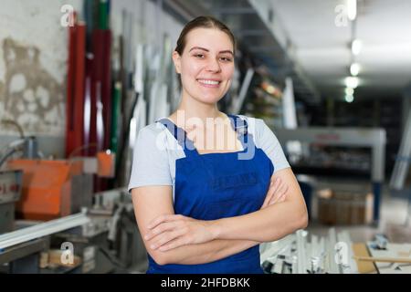 Portrait of female master who is working on her workplace in the window ...