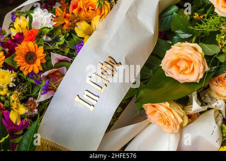flowers at the grave with sentence in love Stock Photo - Alamy