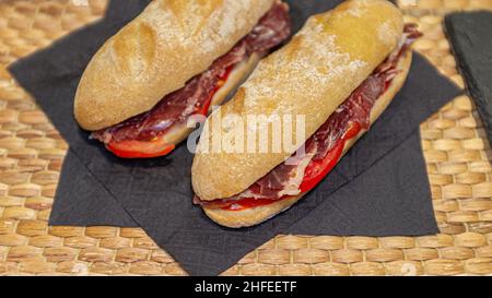 Iberian ham and tomato gourmet snack Stock Photo - Alamy