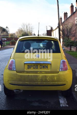 Bright yellow colour Fiat 500 Cinquecento- typical Italian small city ...