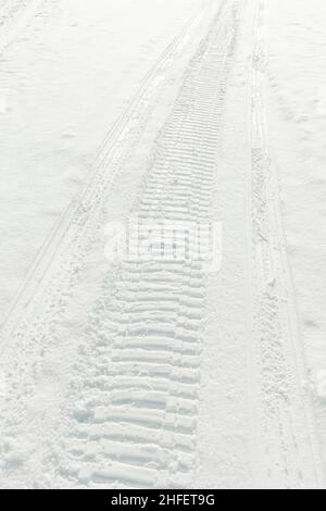 Trail of snow scooter wheel in fresh snow Stock Photo - Alamy