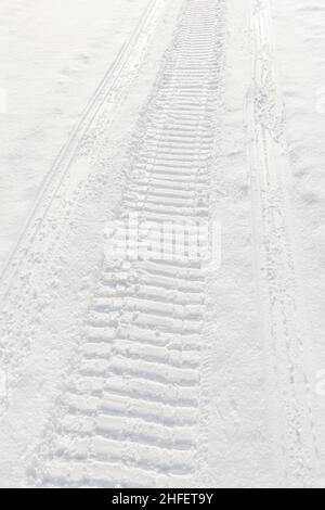 Trail of snow scooter wheel in fresh snow Stock Photo - Alamy