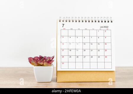 The July 2022 desk calendar with plant on wooden table Stock Photo - Alamy