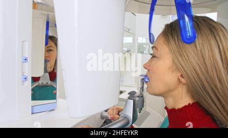 Female patient having computer tomography of jaw, circular snapshot of ...