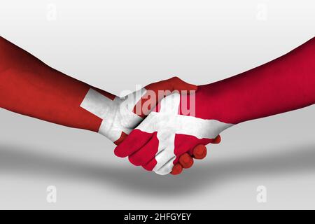 Handshake between switzerland and denmark flags painted on hands ...