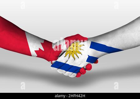 Handshake between canada and uruguay flags painted on hands ...