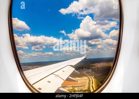 lookout of aircraft window to landscape while landing Stock Photo - Alamy