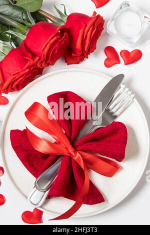 Beautiful table setting for Valentine's Day with red roses on white ...