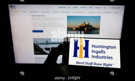 Cellphone with logo of American shipbuilding company HII Corporate on ...