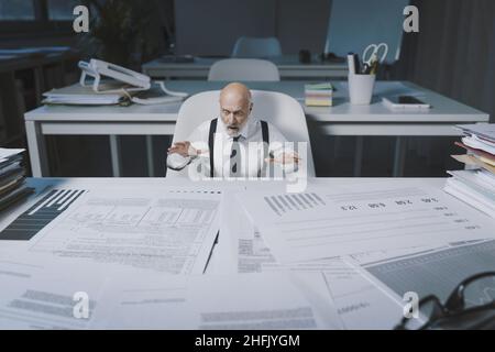 Desperate shocked businessman checking his company financial stats and ...