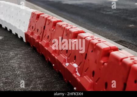 Red and white plastic barriers blocking the asphalt road Stock Photo ...