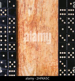 Heap of vintage black domino tiles on wooden table Stock Photo - Alamy