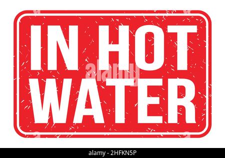 IN HOT WATER, words written on red rectangle stamp sign Stock Photo - Alamy