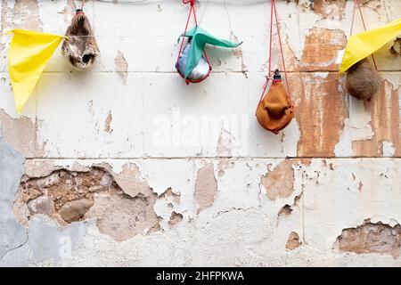 Assortment of Spanish handcrafted wineskin hanging on the facade of a ...