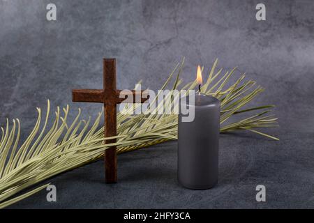 Catholic Cross with palm leaf and burning candle. Ash Wednesday, Lent ...