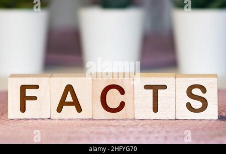 facts word written on wood blocks beige background Stock Photo - Alamy