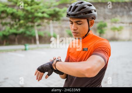 cyclist check his workout progress on a smart watch Stock Photo - Alamy