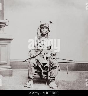 Vintage photo of Winnebago man, full-length portrait, seated, facing ...