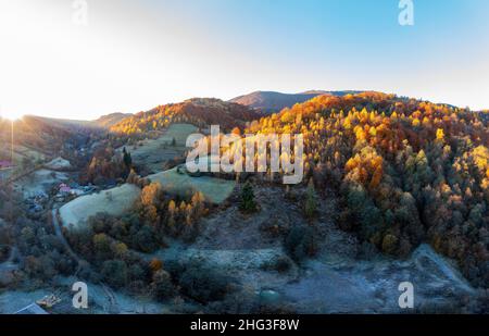 Shaded mountain valley with scattered houses and terracotta-colored ...