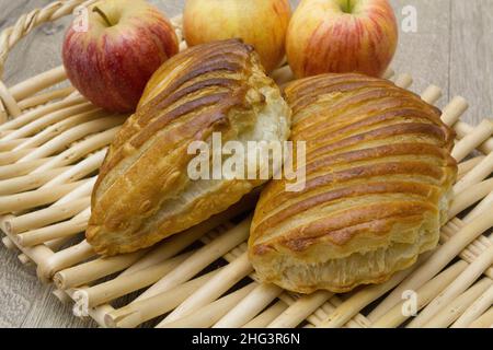 apple turnovers with apples on a basket Stock Photo - Alamy