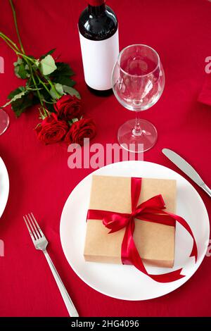Beautiful table setting, present for Valentine day and hearts on color ...