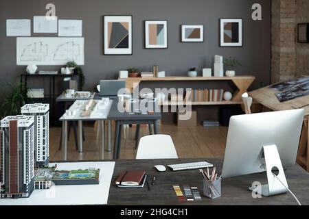 Large workshop of architects with house layout, desktop hardware ...