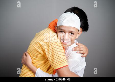 Happy Hindu Muslim Children Hugging Each Other and looking camera with ...