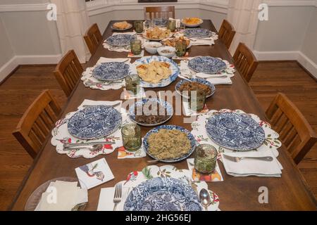 The Wigilia table is set with a white tablecloth under which is placed ...