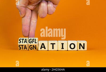Stagflation or stagnation symbol. Businessman turns cubes, changes the ...