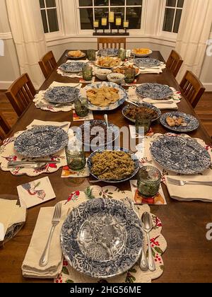 The Wigilia table is set with a white tablecloth under which is placed ...